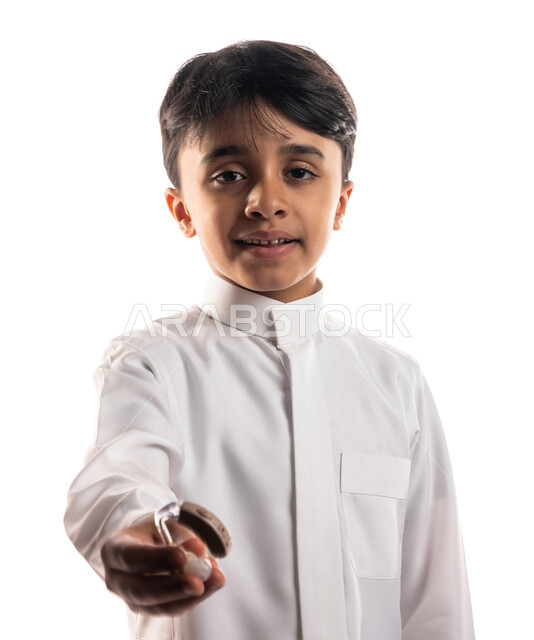 Portrait of a Saudi Arabian Gulf boy, deaf, holding in his hand a ...