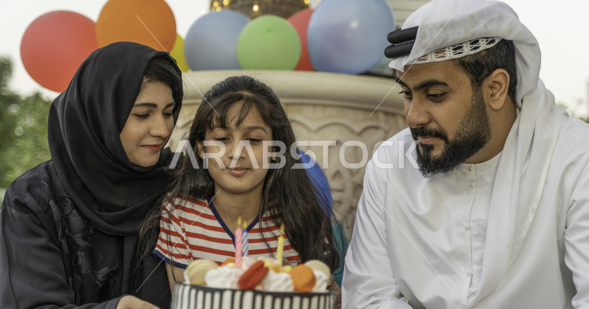 Balloons and a birthday cake decorated with candles, an Emirati Arab ...