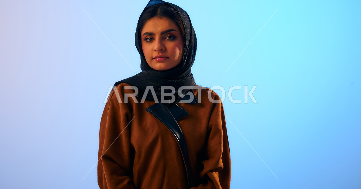 Portrait of a Saudi Arab Gulf woman wearing an elegant colorful abaya ...