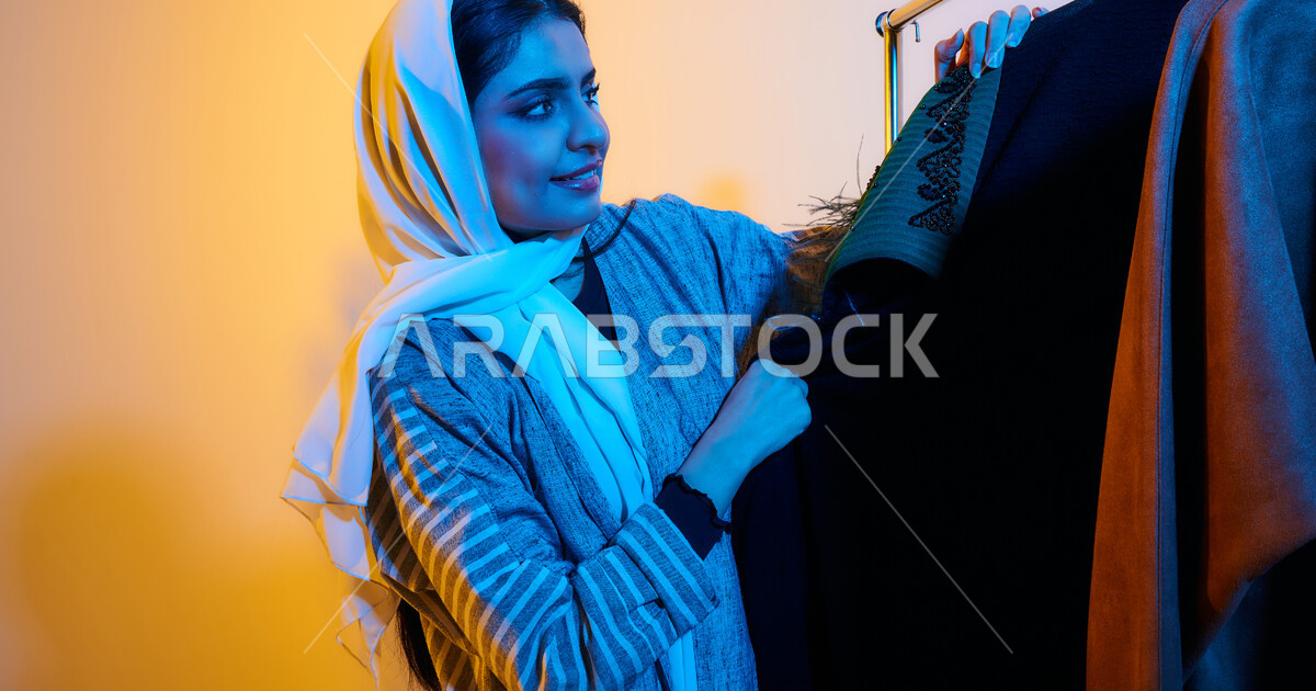 Portrait of a Saudi Arab Gulf woman wearing an elegant colorful abaya ...