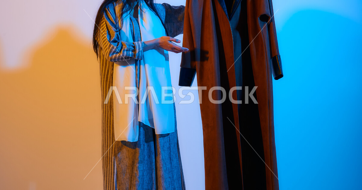Portrait of a Saudi Arab Gulf woman wearing an elegant colorful abaya ...