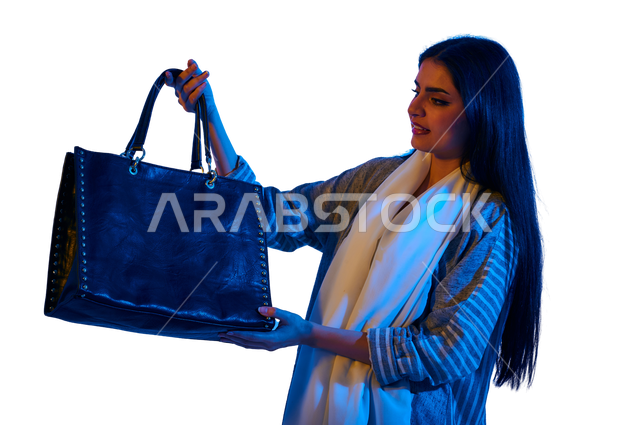 Portrait of a Saudi Arab Gulf woman wearing an elegant colorful abaya ...