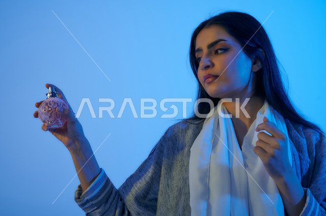 Portrait of a Saudi Arabian Gulf woman applying perfume, the concept of ...