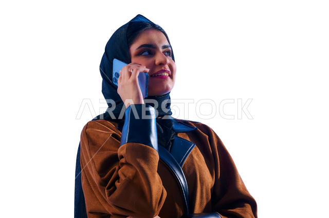 Portrait of a Saudi Arab Gulf woman, holding a mobile phone in her hand ...