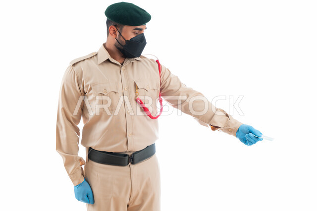 Wearing a protective mask and gloves, a portrait of an Arab Gulf ...