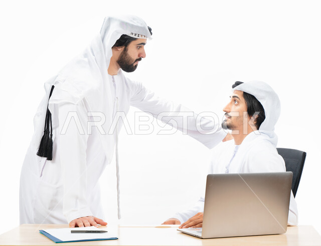 Portrait of two Arab Gulf Emirati businessmen at the workplace ...