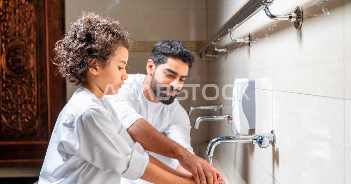 An Emirati Arab Gulf man and his son in places designated for ablution ...