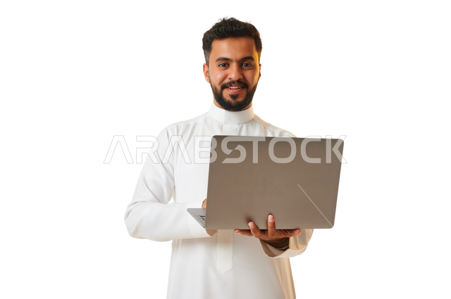 Portrait of a Saudi Arab Gulf man holding a laptop in his hand, working ...