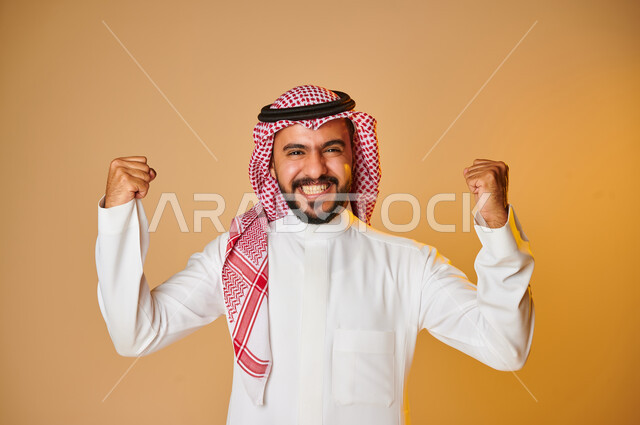 Portrait of a smiling Saudi Arab Gulf youth, facial gestures indicating ...