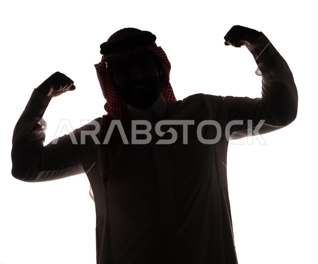 Portrait, silhouette of a Saudi Arabian Gulf man, raising his hands ...
