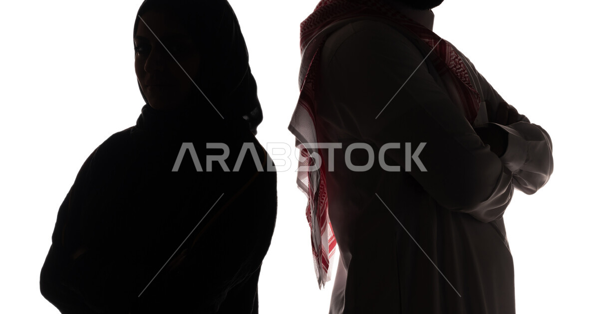 Portrait, silhouette of a Saudi Arabian Gulf couple, standing straight ...