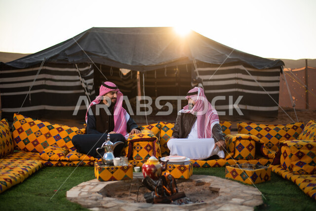 Two young Saudi Arabian Gulf men dressed in warm winter clothes, good ...