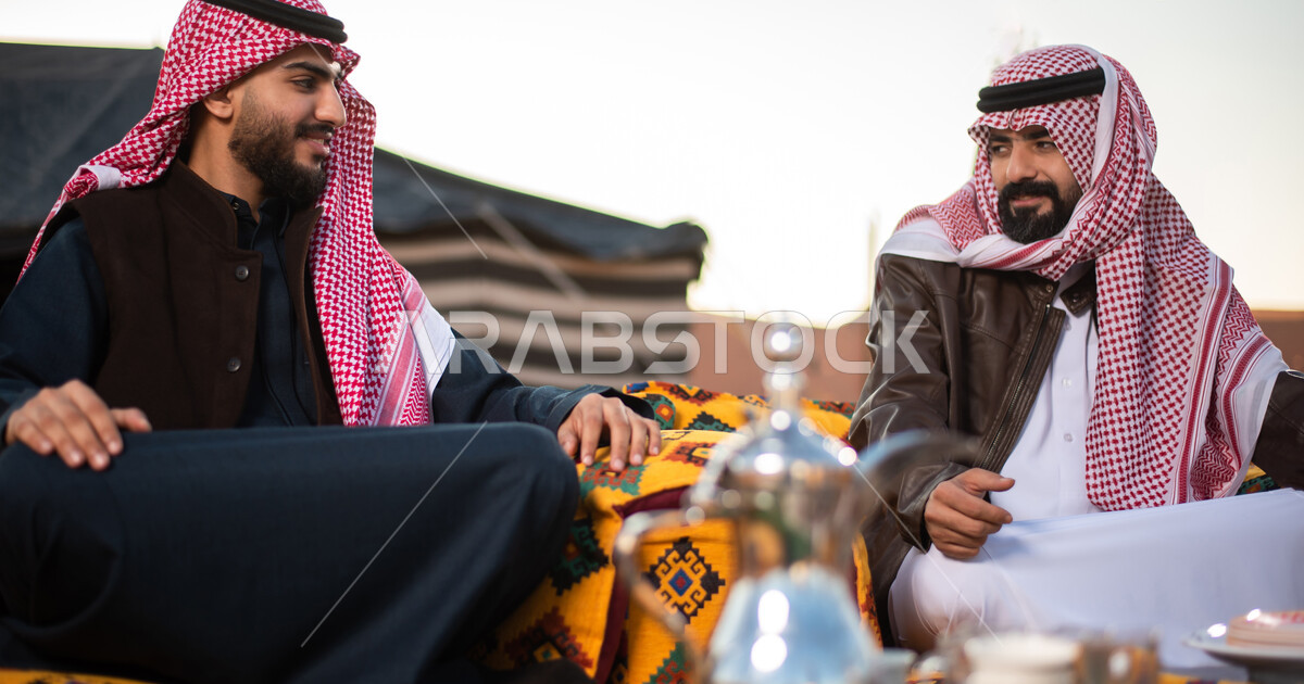 Two young Saudi Arabian Gulf men enjoying a wild camping trip in the ...