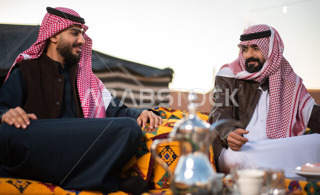 Two young Saudi Arabian Gulf men enjoying a wild camping trip in the ...