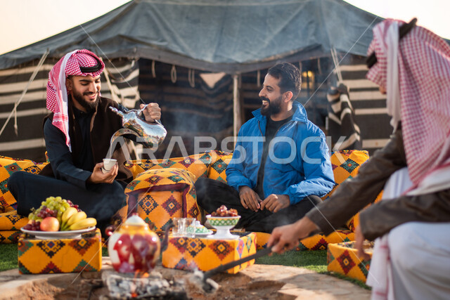 Gulf Saudi Arab friends enjoying a wilderness trip in the desert ...