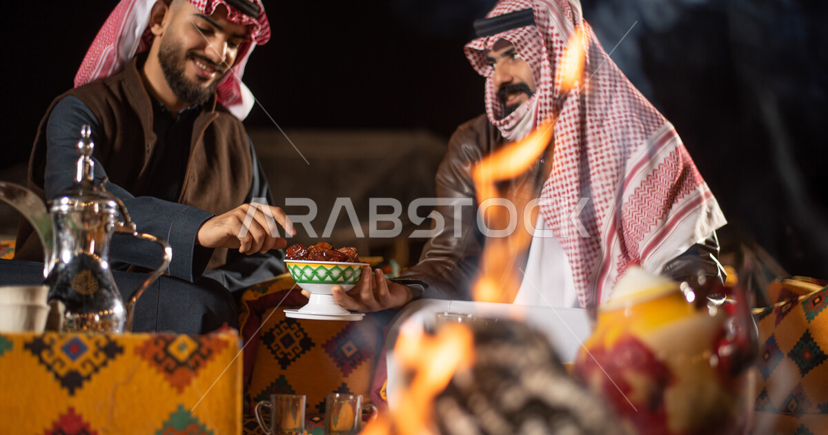 A close-up of two Saudi Arabian men dressed in traditional Saudi dress ...