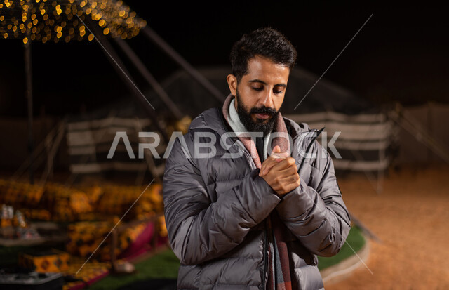 A young Saudi Arabian Gulf man wearing a winter jacket, warm winter ...
