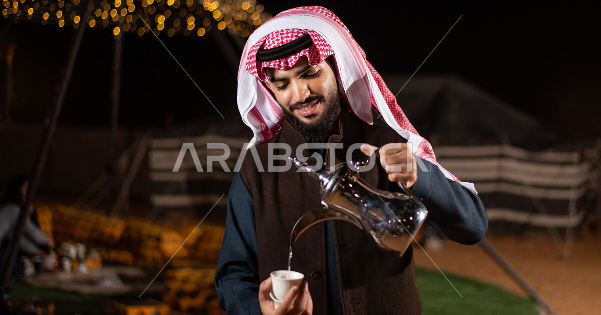 A Saudi Arab Gulf man wearing warm winter clothes and holding in his ...