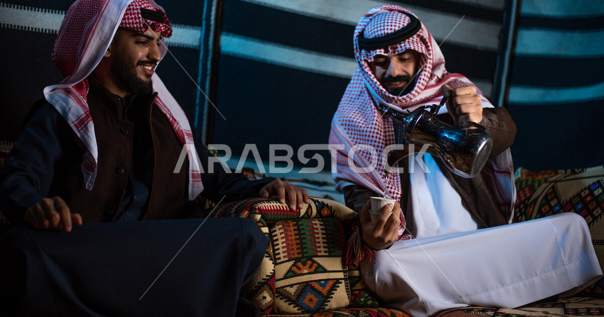 Two Saudi Arab Gulf men enjoying a wild camping trip in the desert of ...