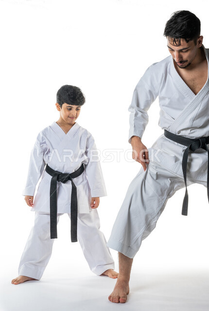Portrait of a Saudi Arabian Gulf child wearing a white karate uniform ...