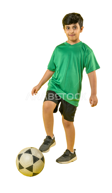 Playing football, a portrait of a Saudi Arabian Gulf boy wearing sports ...