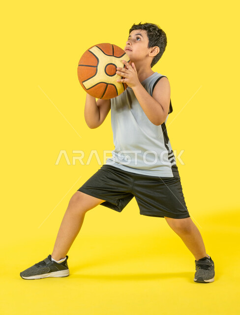 Focusing and planning to throw the ball, a portrait of a Saudi Arabian ...