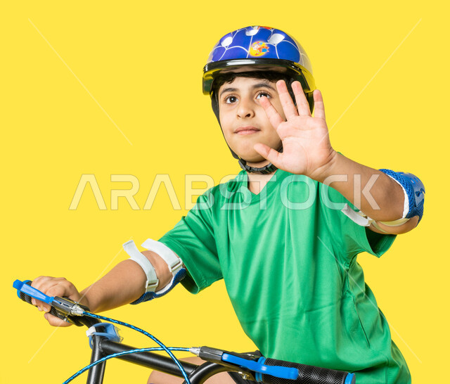 Portrait of a Saudi Gulf Arab child waving his hand, wearing sports ...
