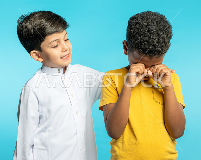 Portrait of a Saudi Arabian Gulf child consoling his sad friend, providing support and support ...
