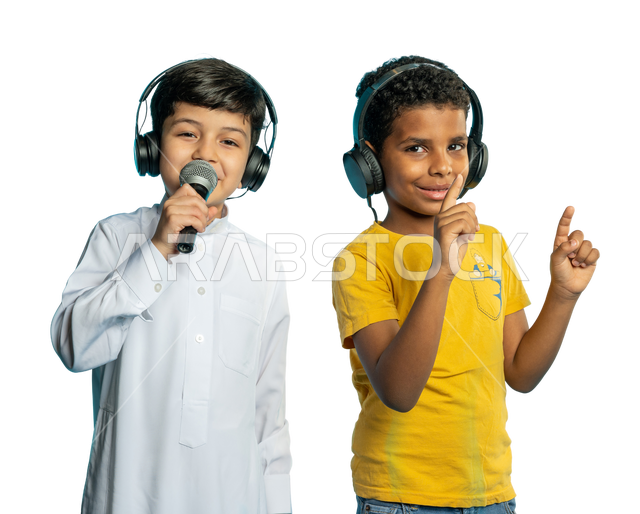 Portrait of two Saudi Arabian Gulf children using a microphone, wearing ...