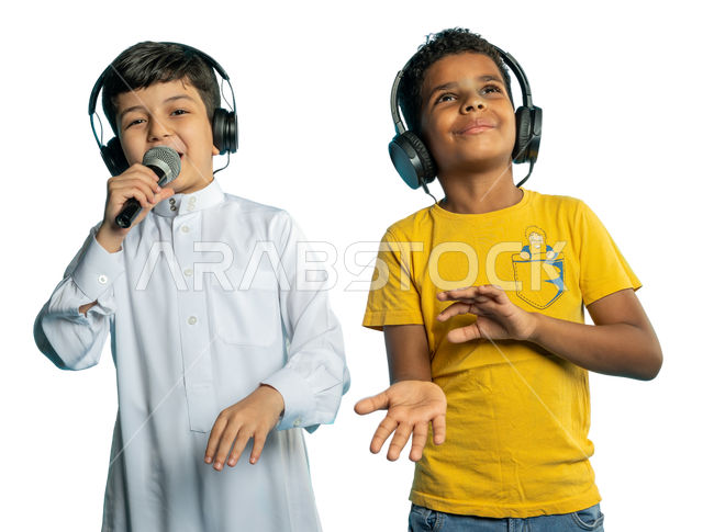 Portrait of two Saudi Arabian Gulf children wearing headphones, two ...