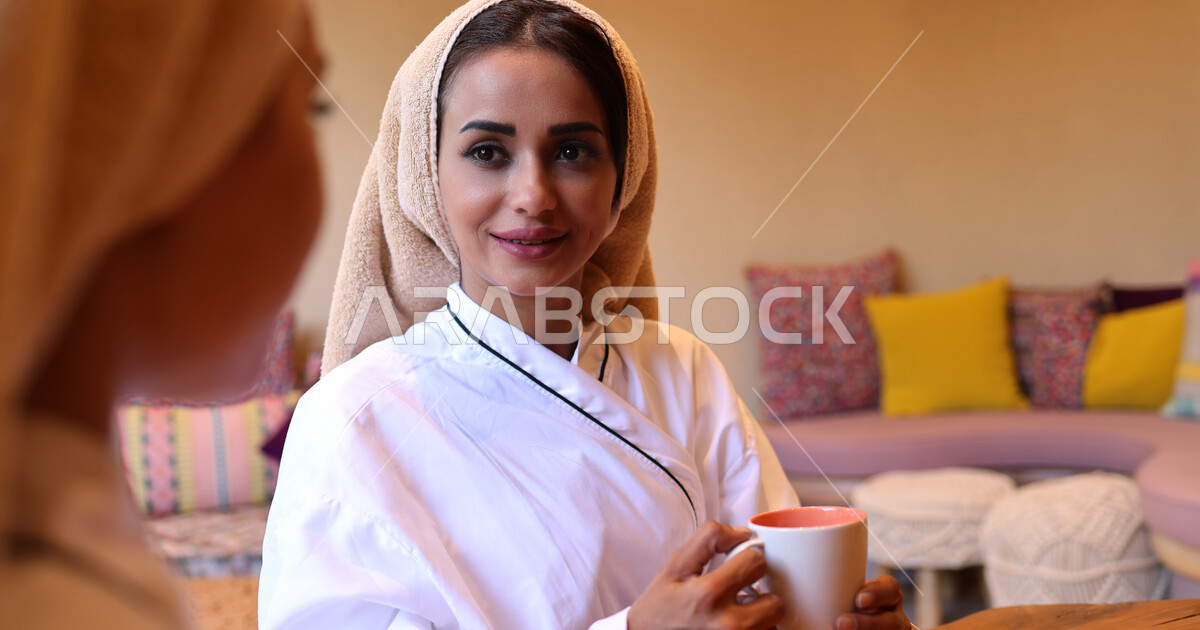 Two Saudi Arab Gulf women in a women's spa, chatting and conversations ...