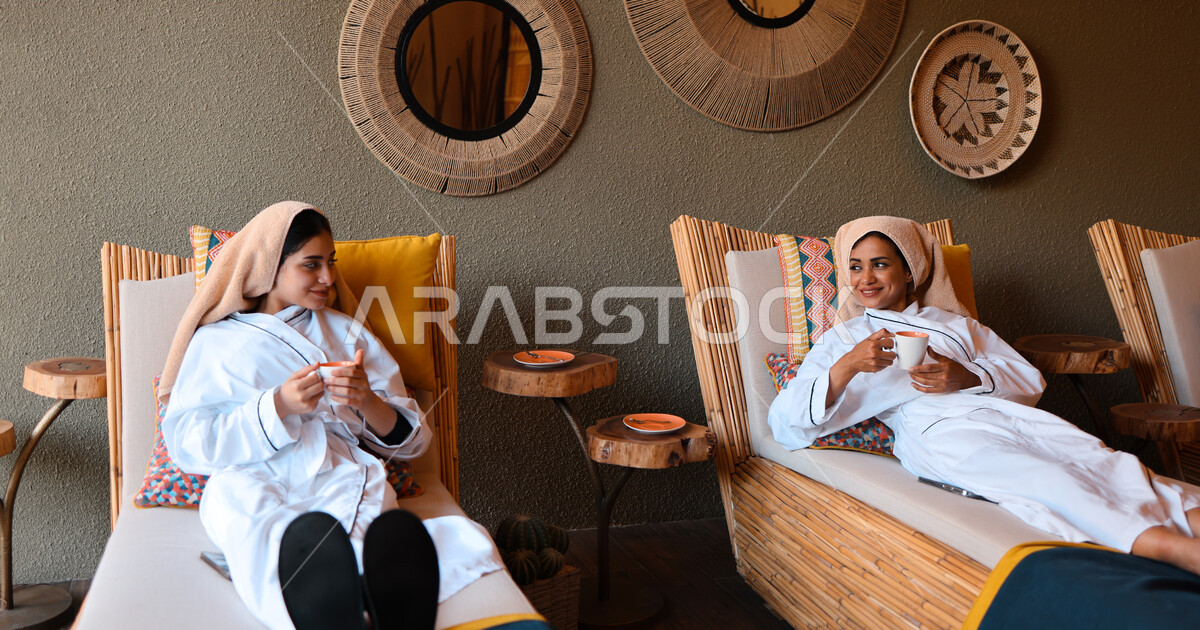 Two Saudi Arab Gulf women in a women's spa, chatting and conversations ...