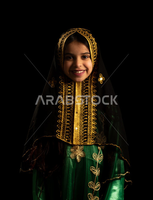 Portrait of a Saudi Arabian Gulf girl wearing a traditional costume for ...