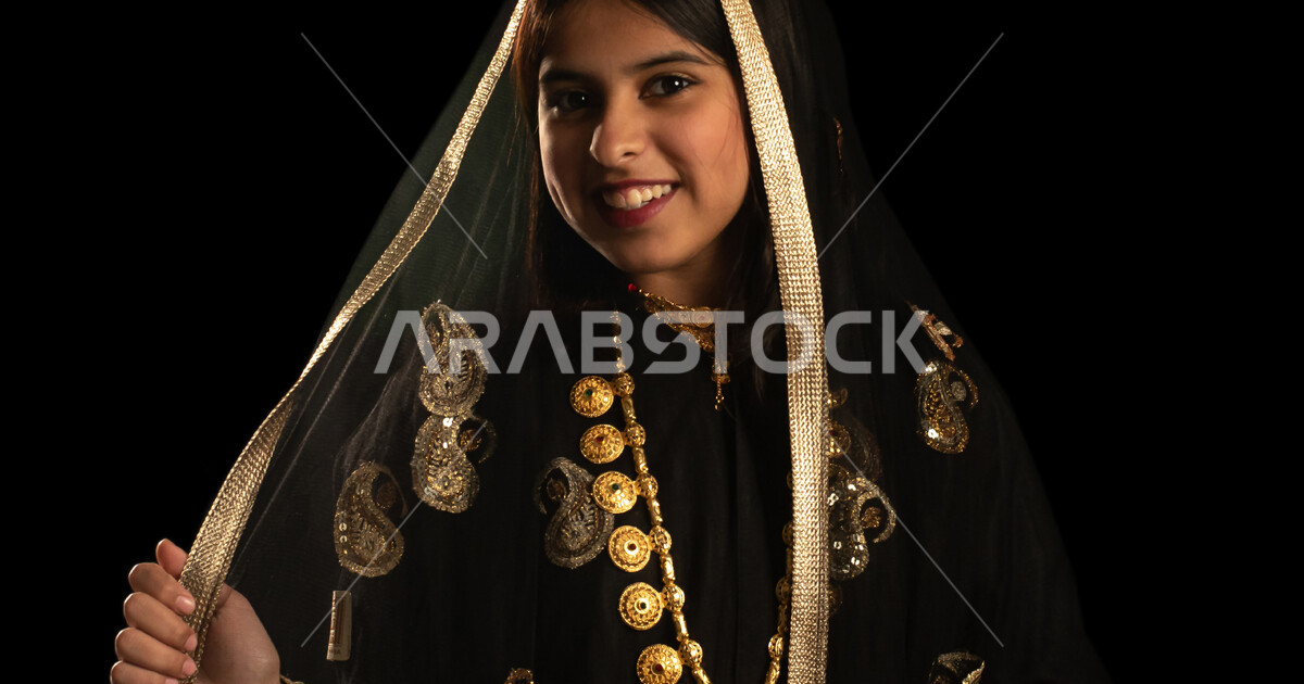 Portrait of a Saudi Arabian Gulf girl wearing a traditional costume for ...