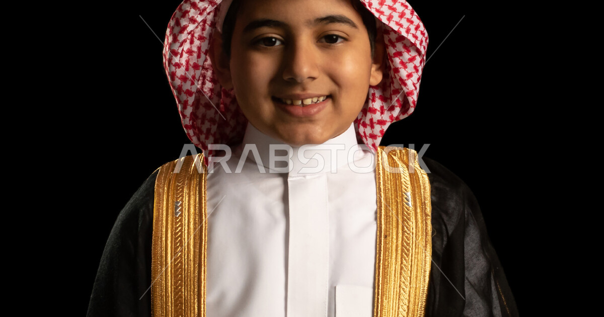 Portrait of a Saudi Arabian Gulf boy wearing the Saudi bisht, a ...