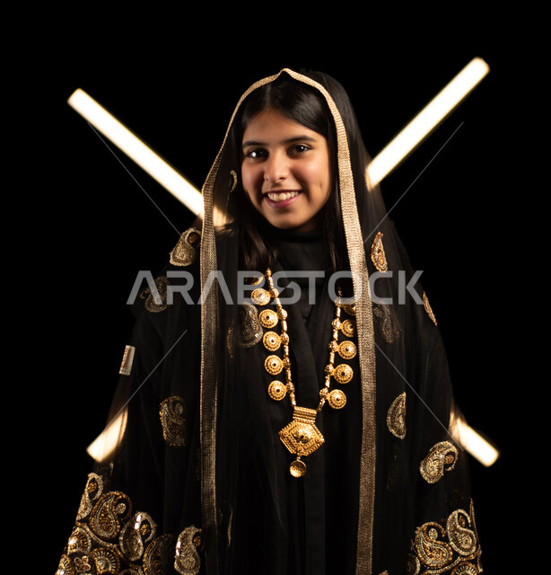 Portrait of a Saudi Arabian Gulf girl wearing a traditional costume for ...