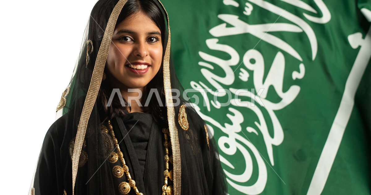 Portrait of a Saudi Arab Gulf girl, the background of the Saudi flag ...