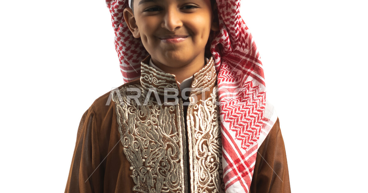 Portrait of a smiling Saudi Arabian Gulf boy, wearing the traditional ...