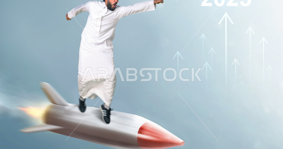 A young Saudi Arabian Gulf man in traditional costume standing on a ...