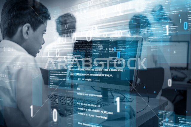 Two Saudi Arabian Gulf students learning programming, sitting in front ...