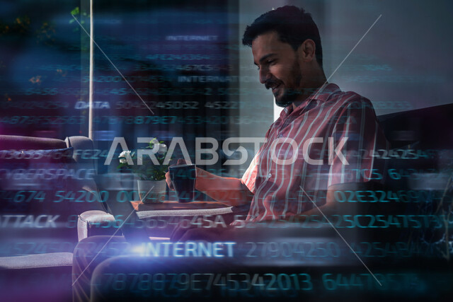 A Saudi Arabian Gulf man using a laptop, working in the development of ...