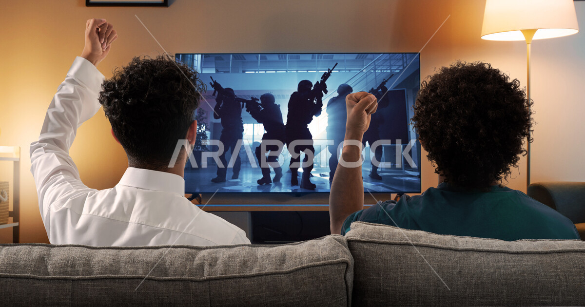 A picture from the back of two Saudi Arabian Gulf youths enjoying ...