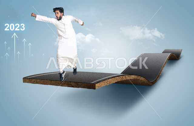 A young Saudi Arabian Gulf man wearing traditional costume and jumping ...