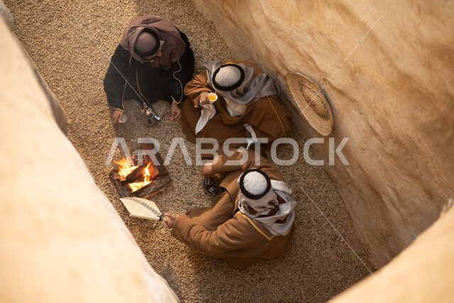 A picture from above of a group of Saudi Arab men, sitting in the ...