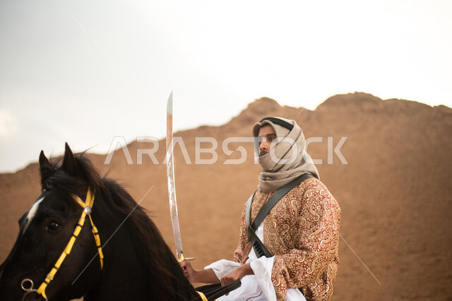 A Saudi Arab Gulf knight riding horses in the Saudi desert, the Saudi ...