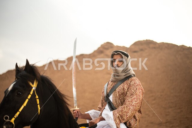A Saudi Arab Gulf knight riding horses in the Saudi desert, the Saudi ...