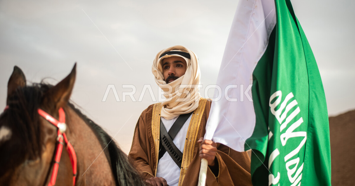 A Saudi Arab Gulf knight wearing a traditional costume and riding a ...