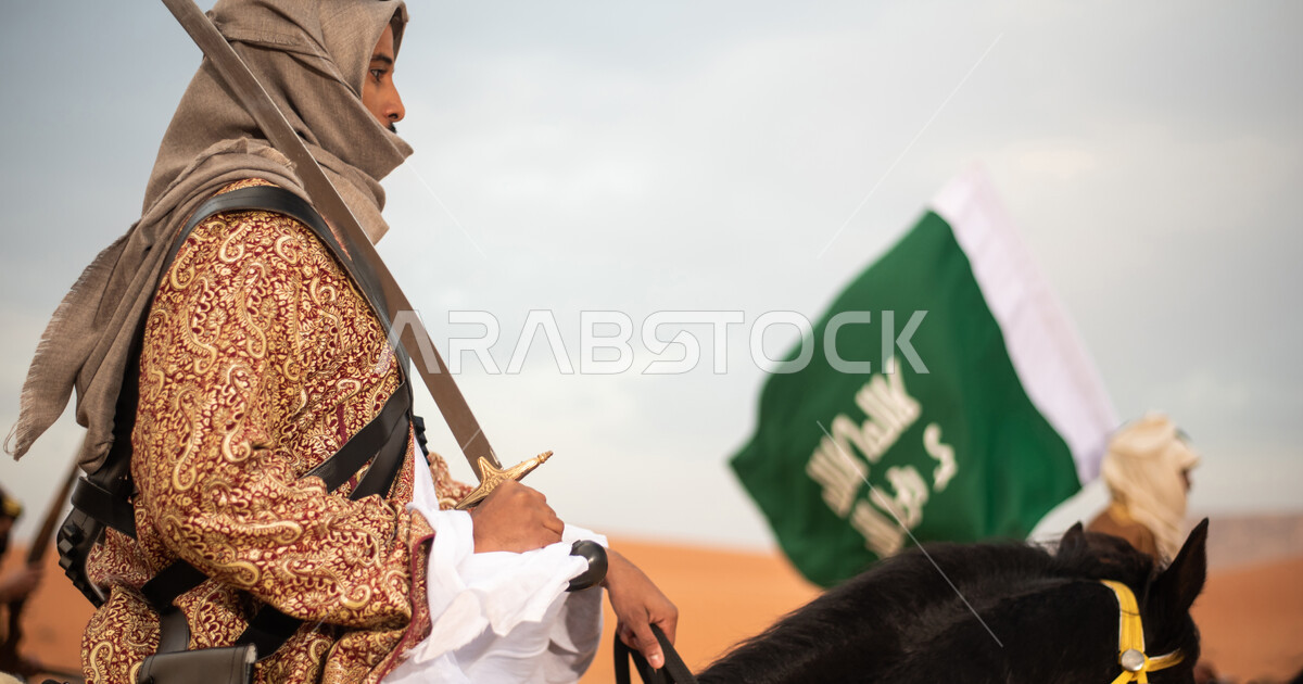 A Saudi Arab Gulf knight riding horses in the Saudi desert, the Saudi ...