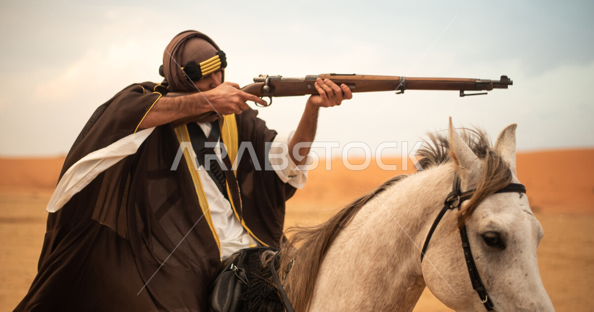 A Saudi Arab Gulf knight riding a horse in the desert of Saudi Arabia ...
