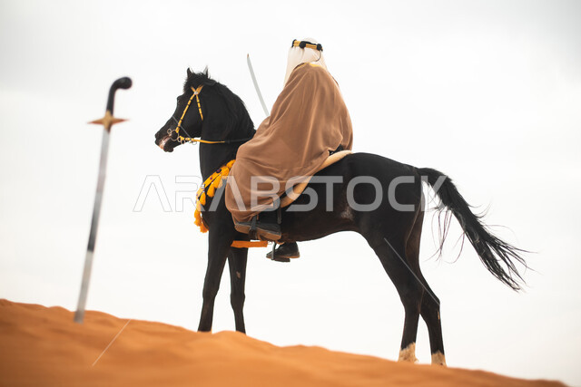 A Saudi Arabian Khaleeji knight riding an Arab horse in the Saudi ...